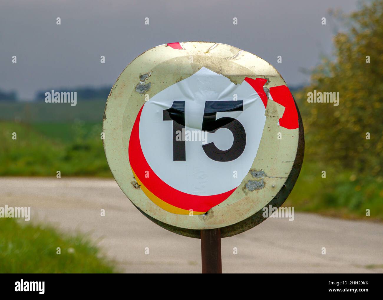 an aged 15 mph speed limit warning enforcement sign worn away by time ...