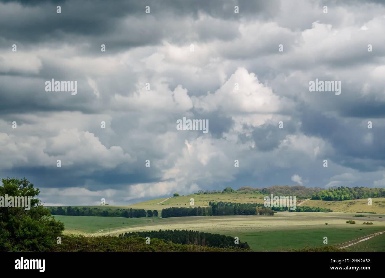a foreboding dramatic dark grey thunder storm cloud sky over a tump and ...