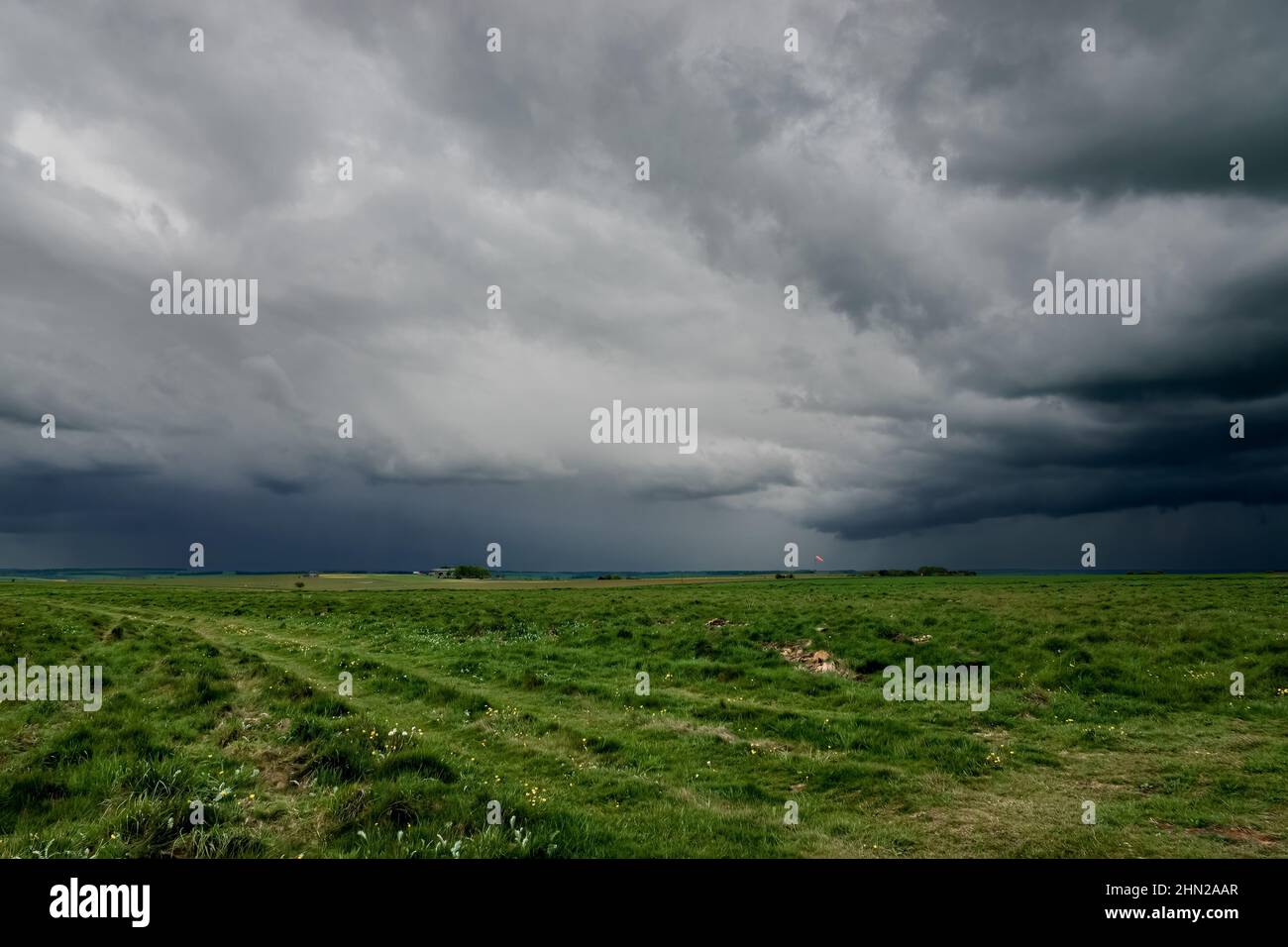 a foreboding dramatic dark grey thunder storm cloud sky over an open ...