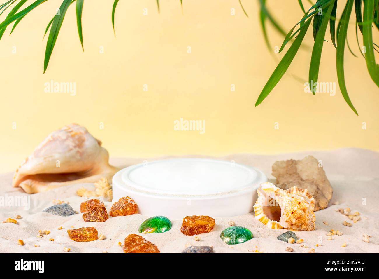 Yellow sandy textured background with white round podium and bright ...