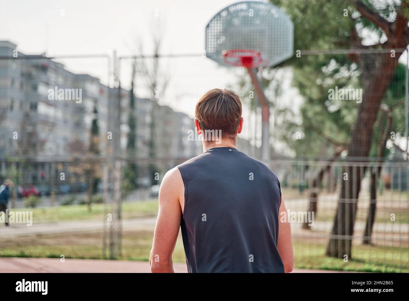 Young player throwing to the basket. Unrecognizable Caucasian man with ...