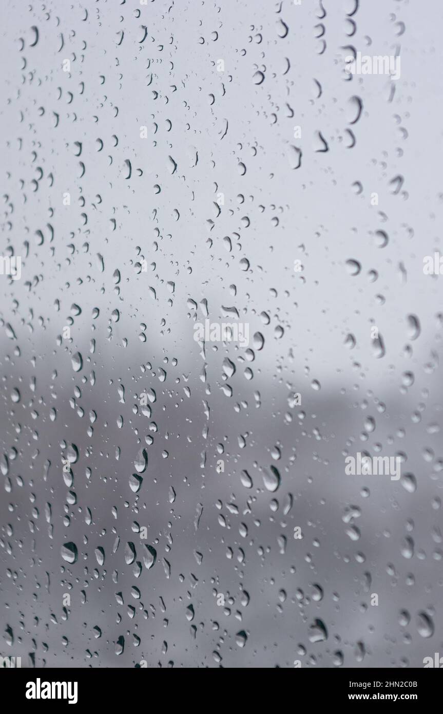 Melting snow on the glass, drops of water condensation on the window ...