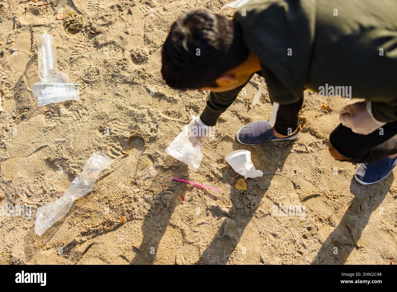 Top view of volunteer protecting environmental and picking up garbage ...