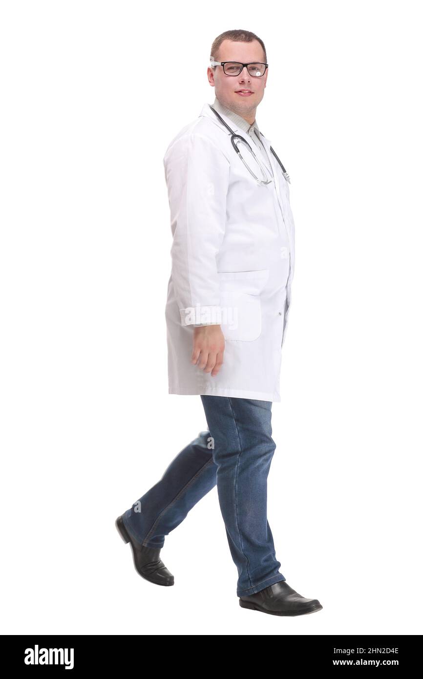 Male doctor walking isolated over a white background looking at camera ...
