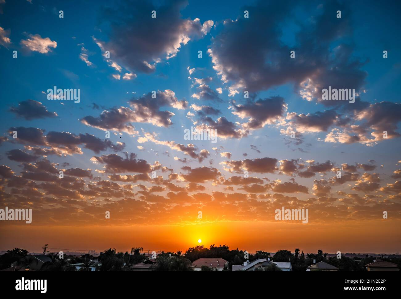 Beautiful view of a sunset over a town Stock Photo - Alamy