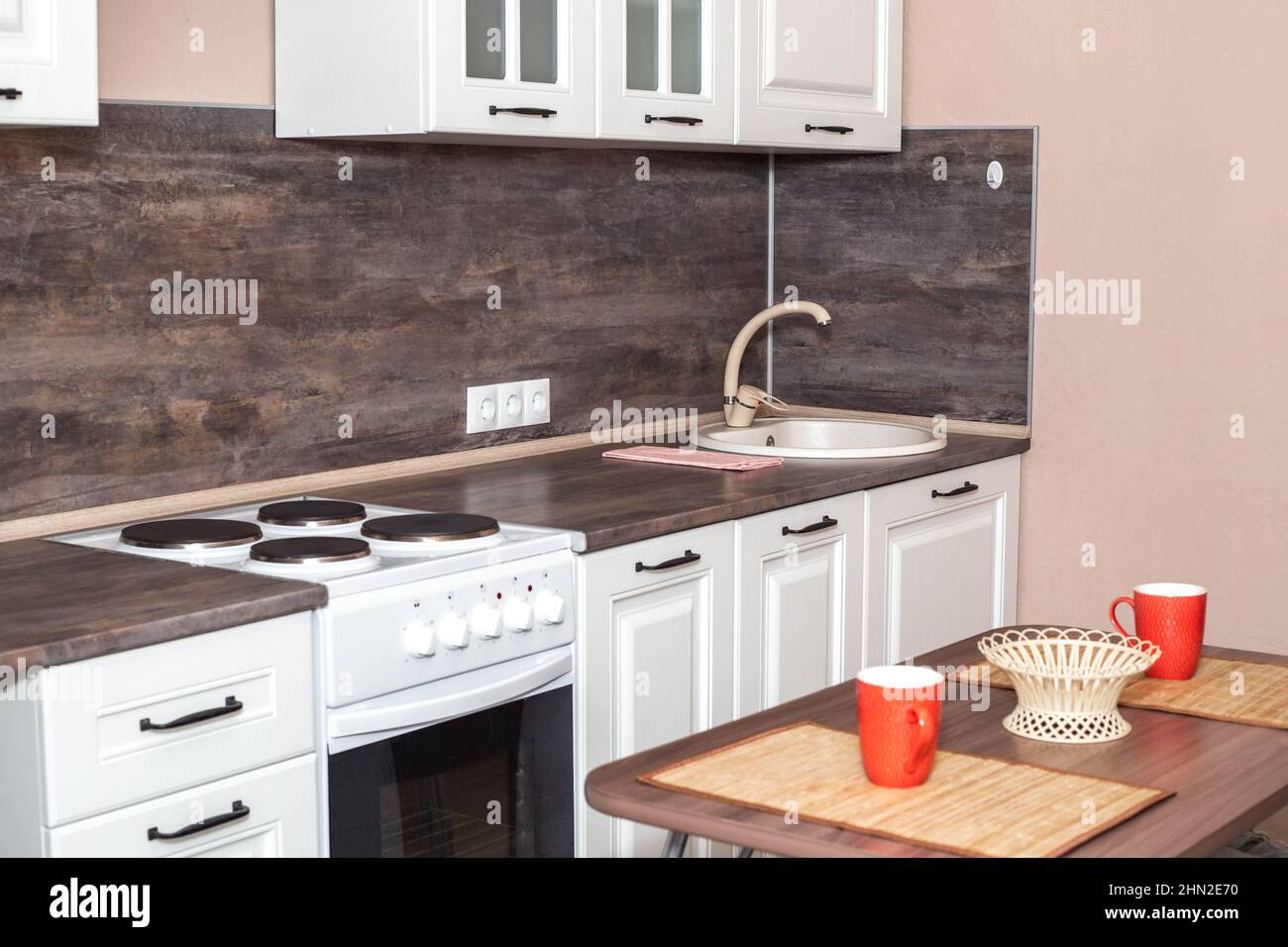 Light kitchen set with wooden worktop and sink, wooden table with ...