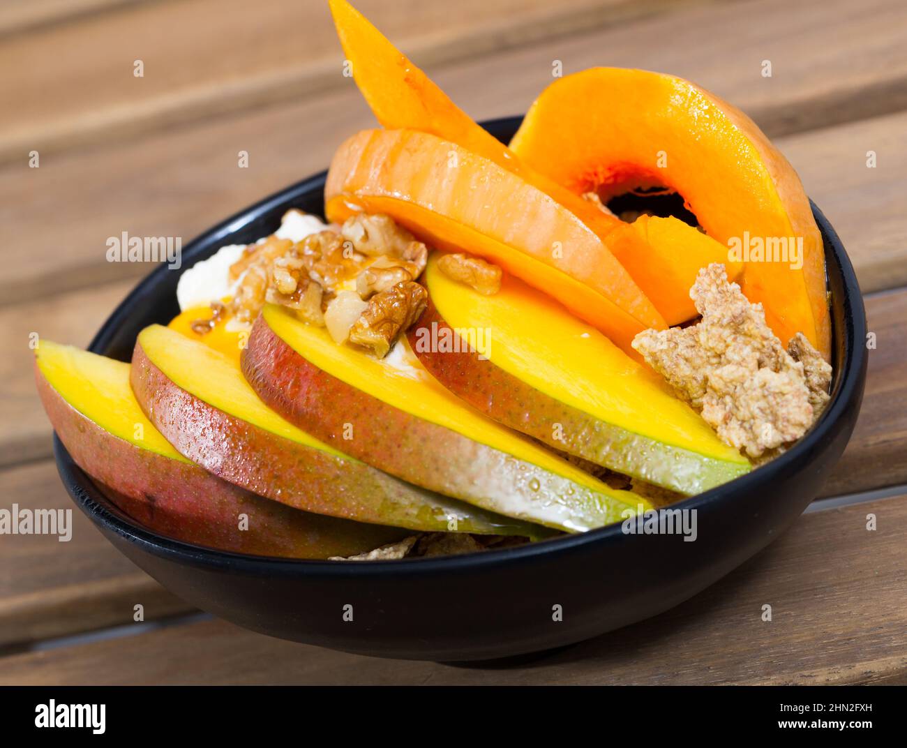 Mango and baked pumpkin with flakes and yogurt Stock Photo - Alamy