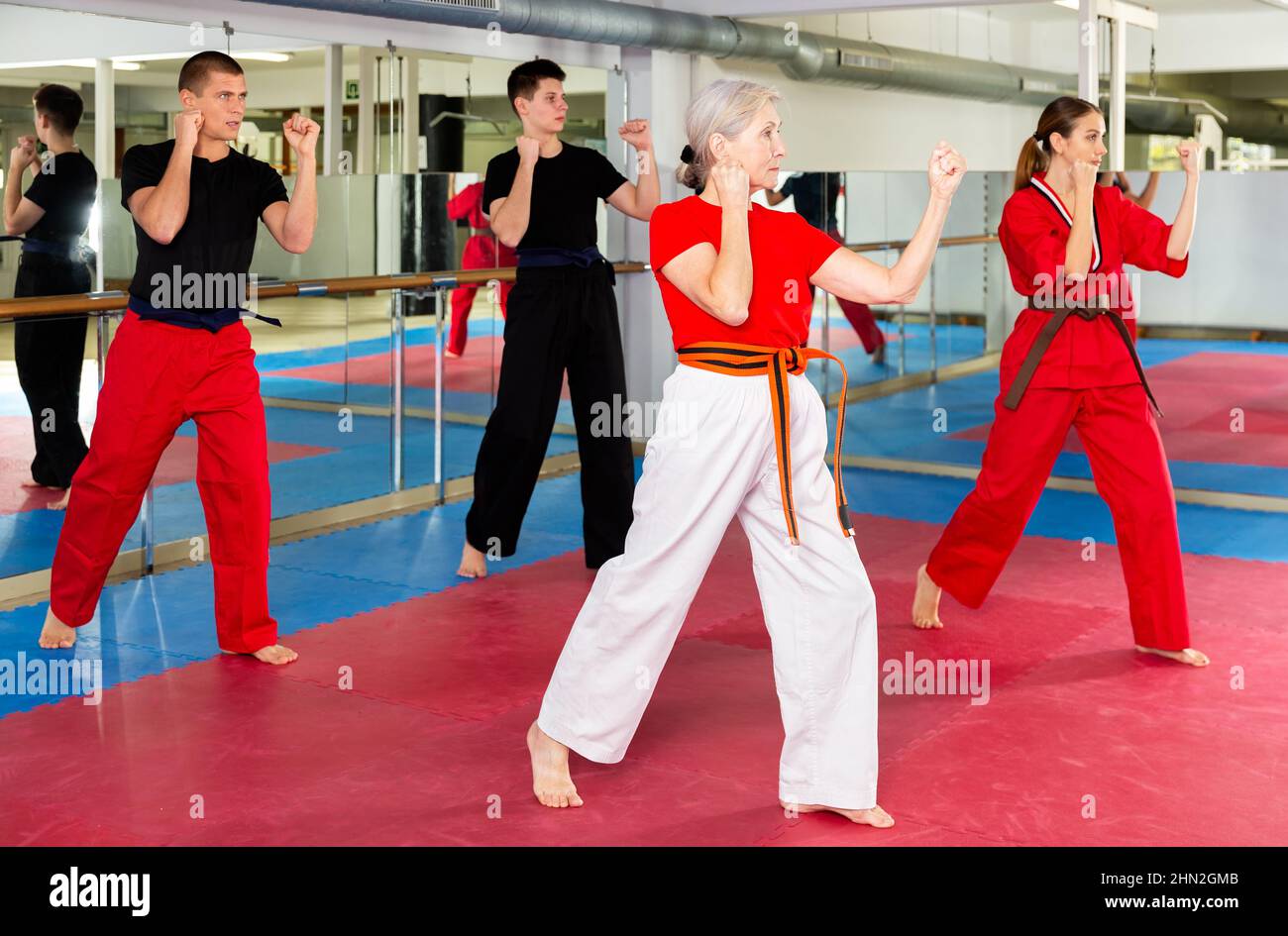Karate or taekwondo training - athletes in kimono stand in fighting ...