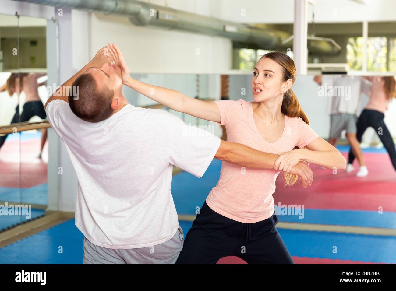 Woman performing chin strike during self-defence training Stock Photo ...