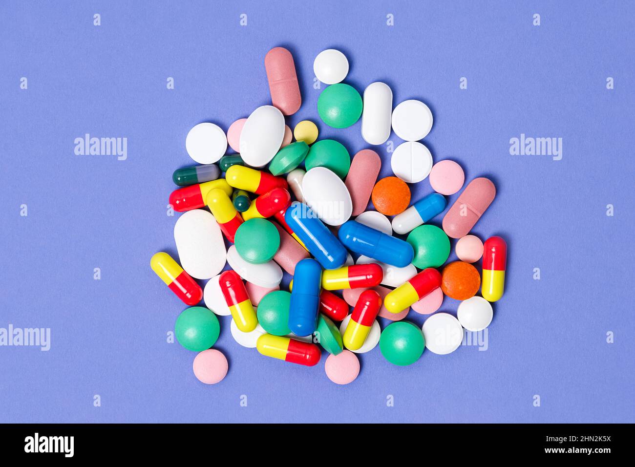 Pile of pills on purple background. Medical background. Pattern made ...