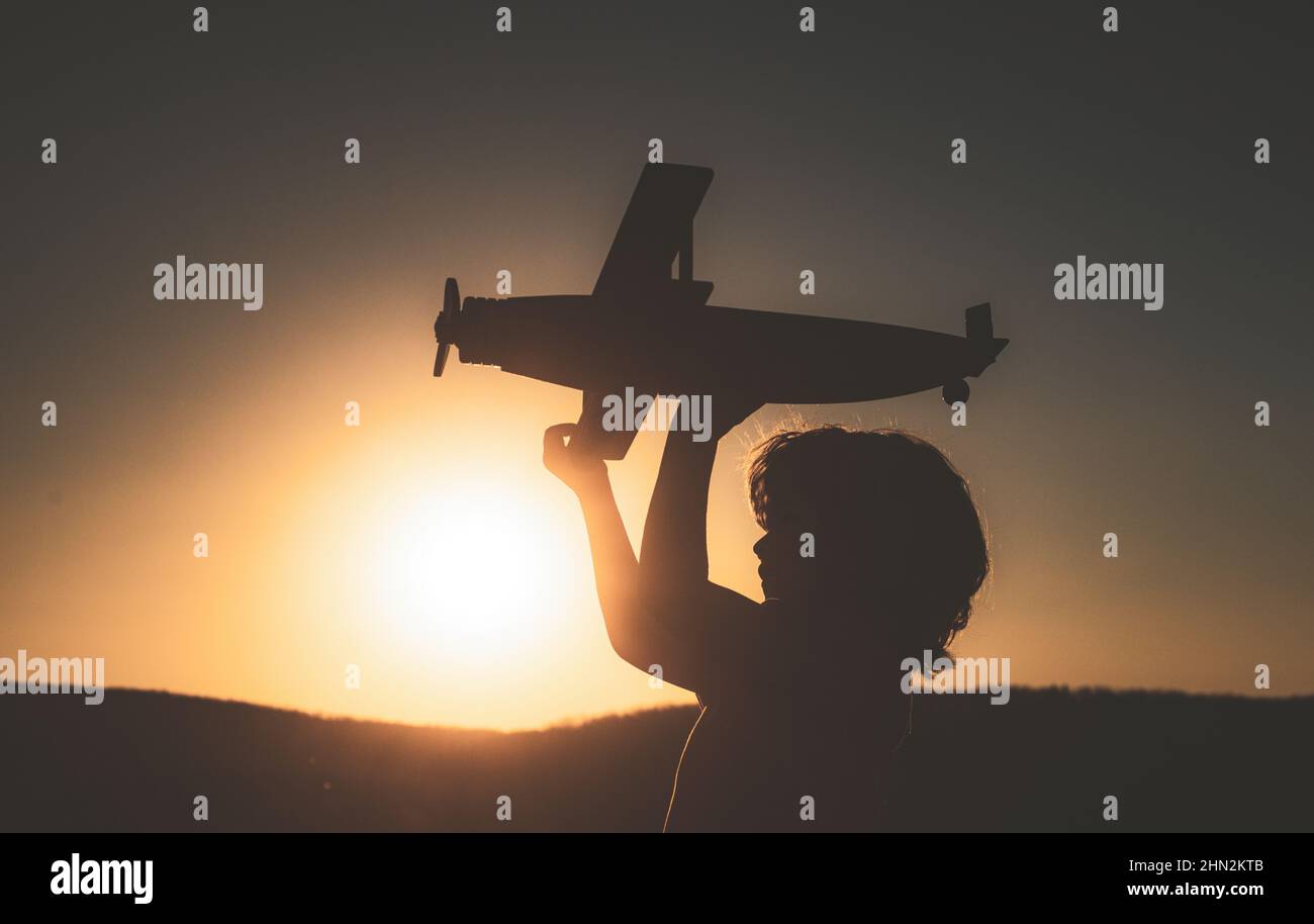 Child pilot aviator with toy airplane dreams of traveling in summer in ...
