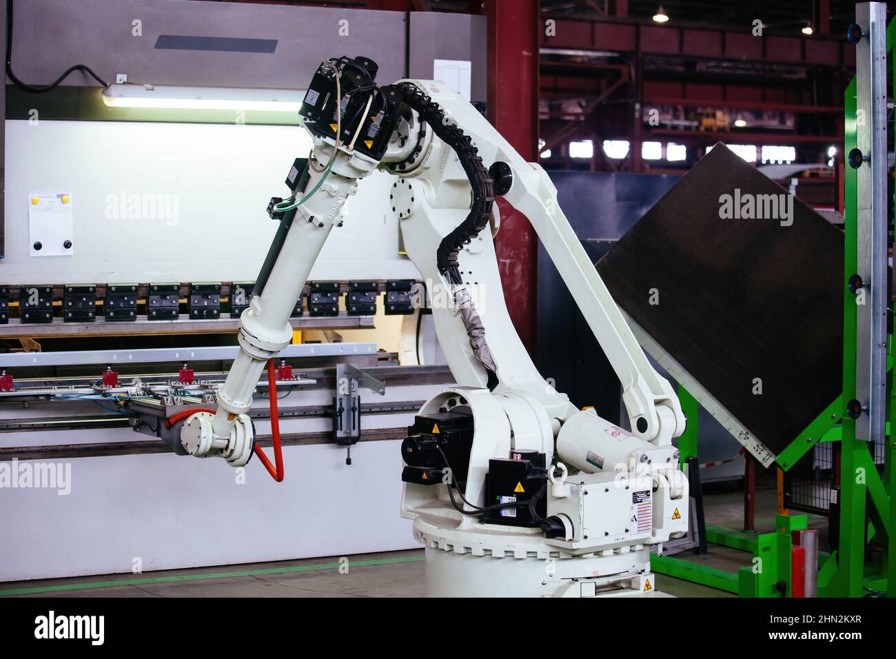 Robotic arm working with metal sheet at hydraulic bending machine Stock ...