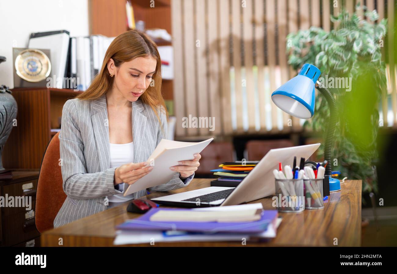 Female secretary doing paperwork in office Stock Photo - Alamy