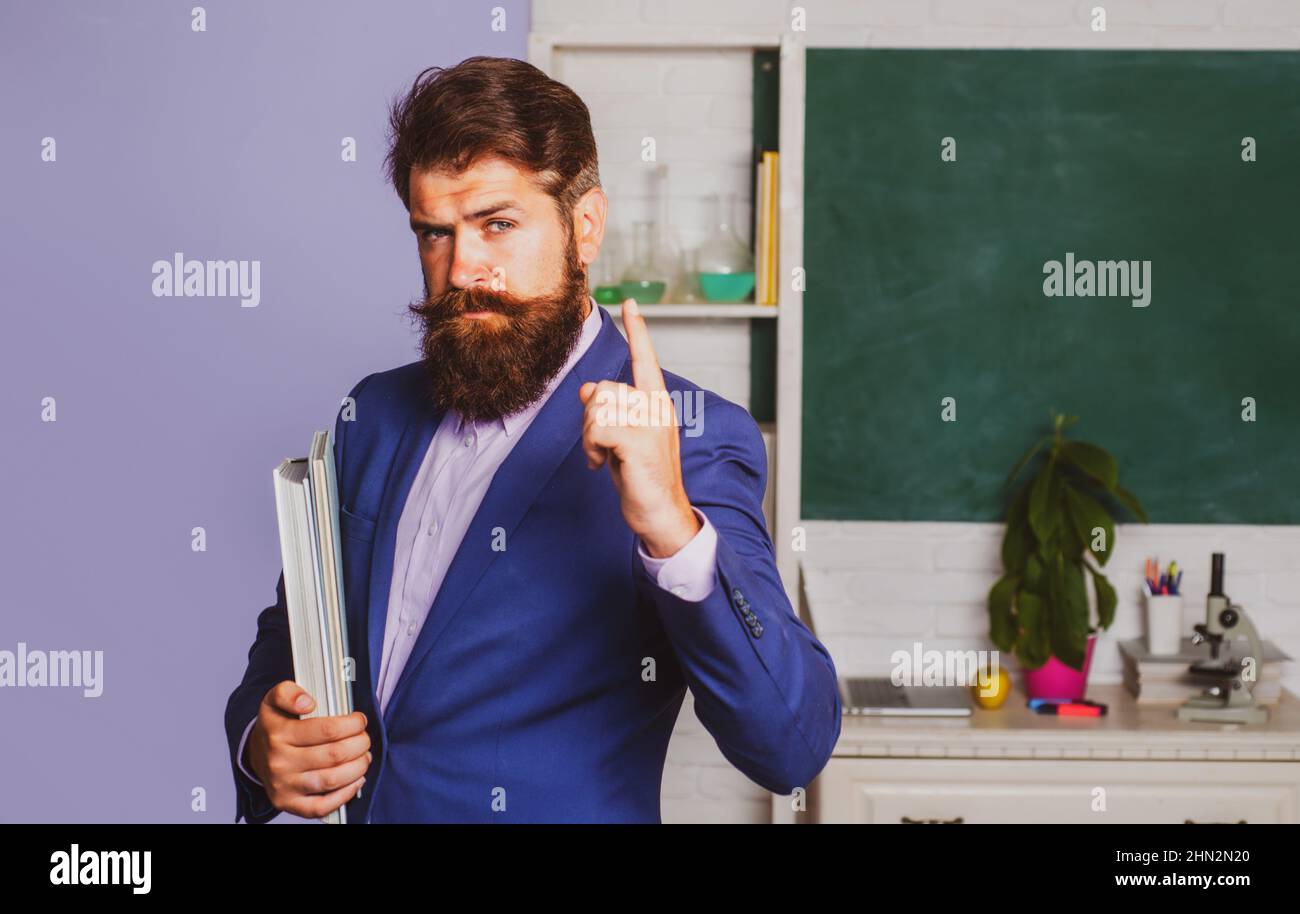 Serious man teacher professor teaching student in classroom. Portrait ...