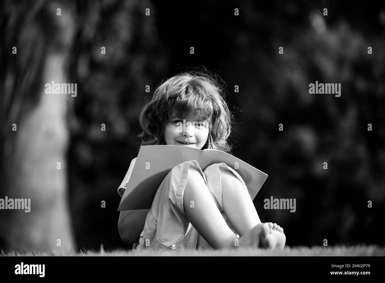Distance children learning using pencil to practice writing on a book ...