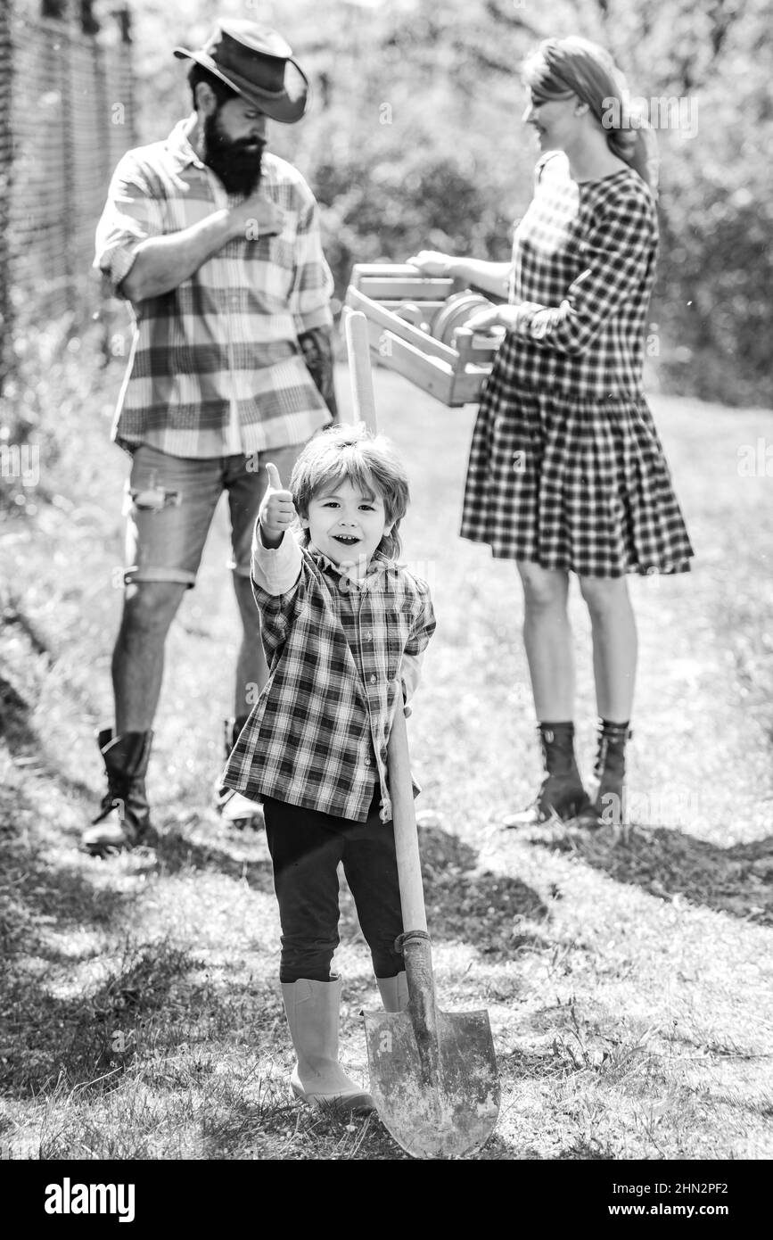 Happy family on farm. Family crop planting at fields. Young family with ...