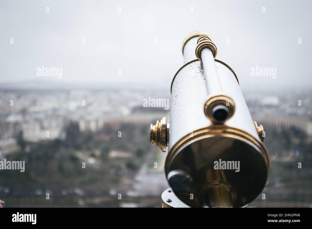 Old metal monocular with rain drops on a blurry urban landscape Stock ...