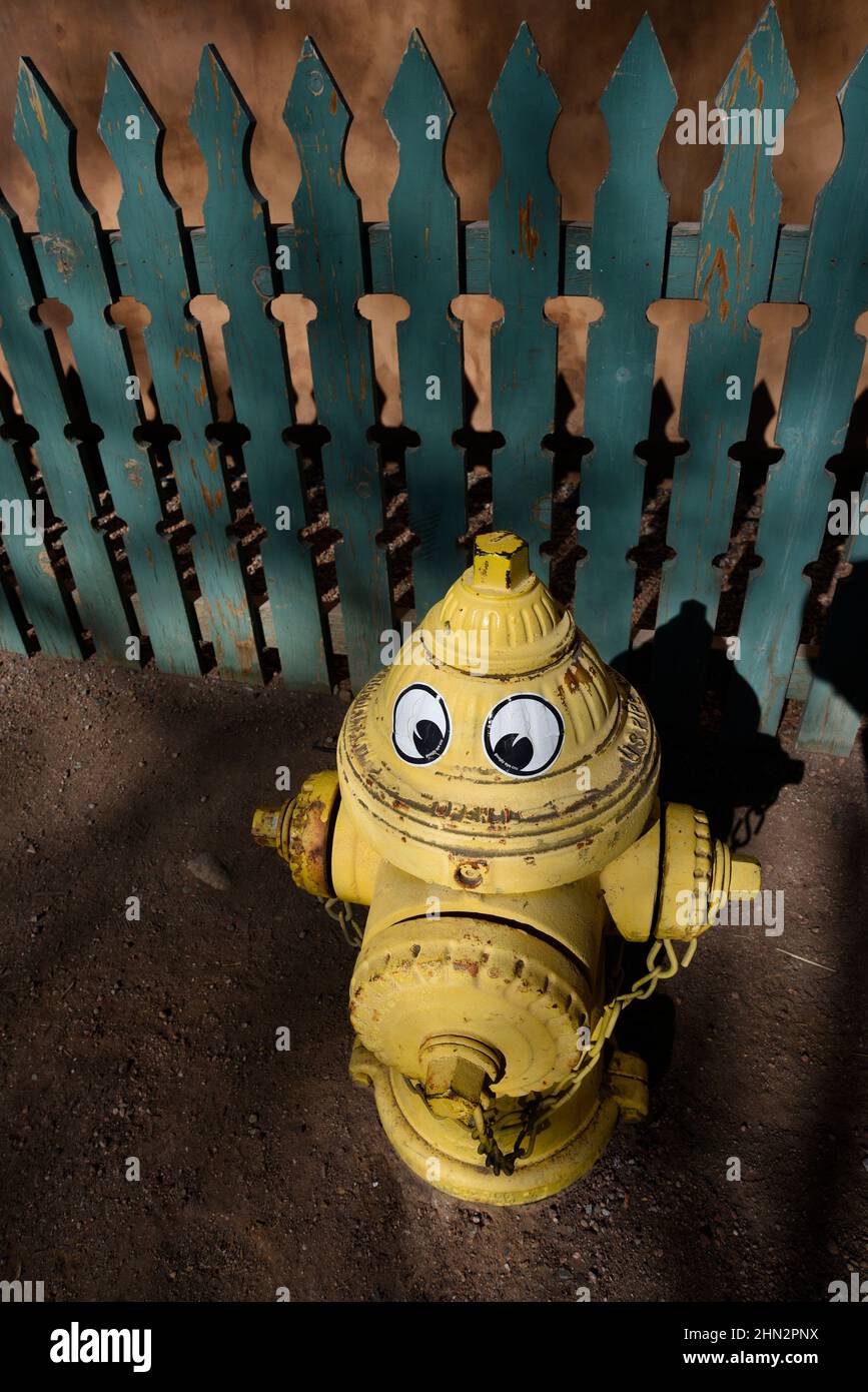 A yellow fire hydrant with humorous decal eyes applied in Santa Fe, New ...