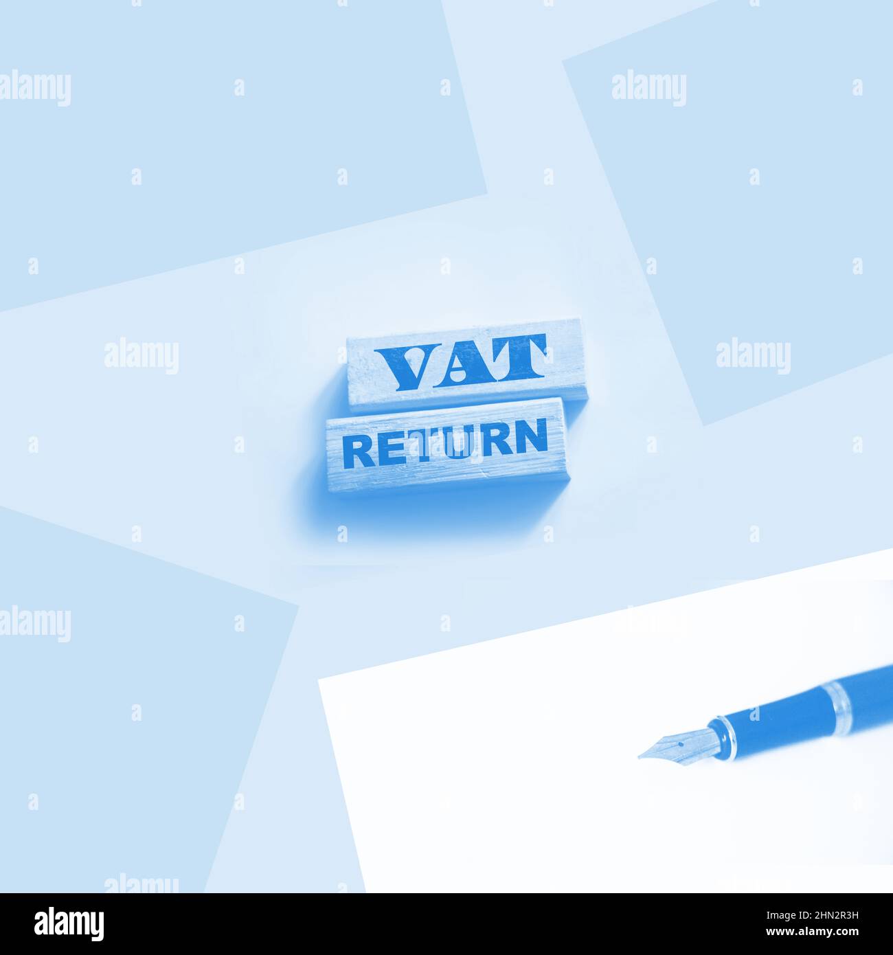 VAT return text Value Added Tax return on wooden blocks on pink ...
