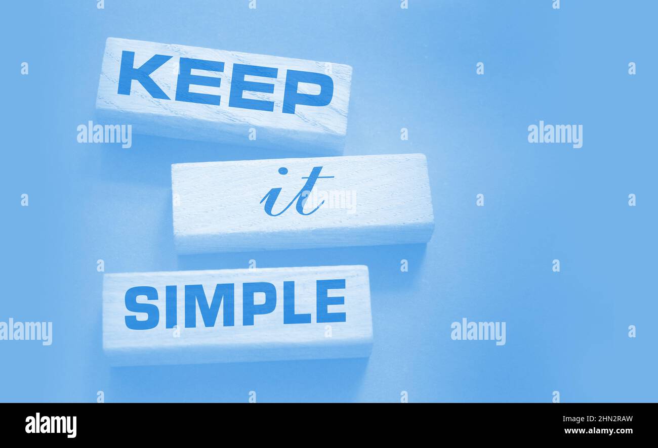 Keep it simple words on wooden blocks on dark gray background. Business ...