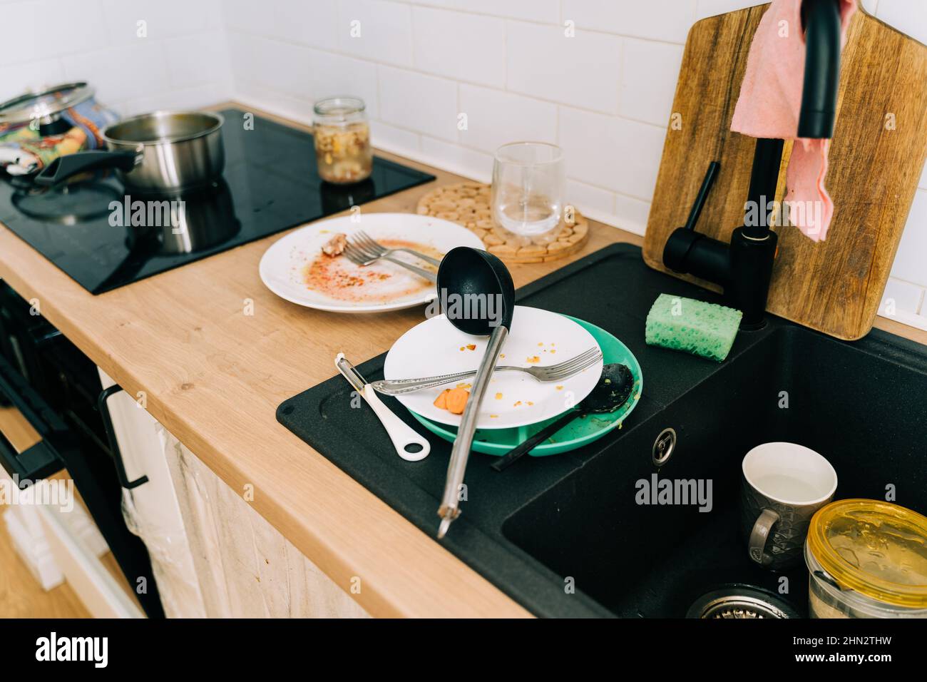 Wooden kitchen tabletop with black sink and dirty messy dish Stock ...