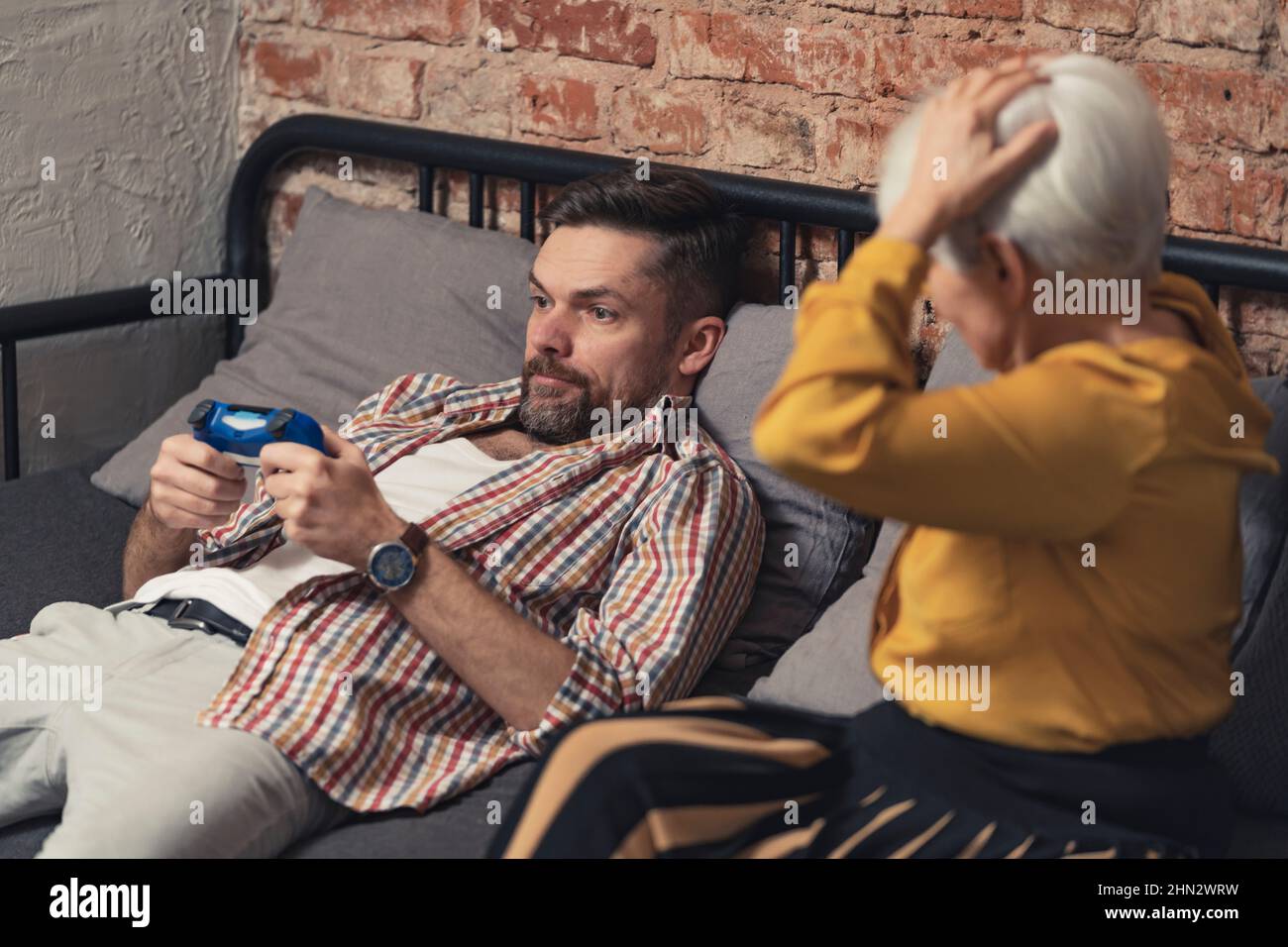 grey-haired caucasian grandmother is impatient with her middle-aged son ...
