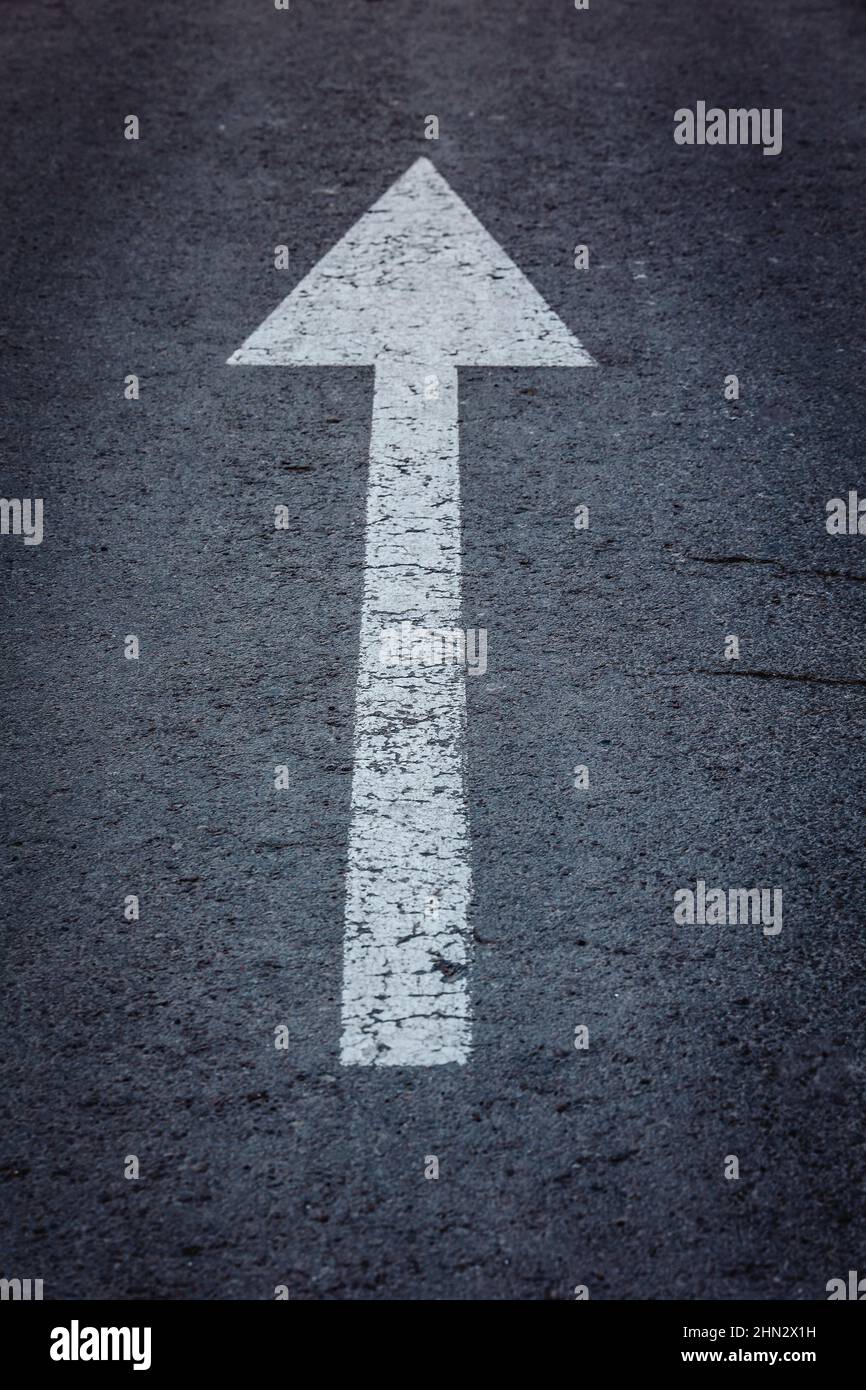 Arrow direction sign on tarmac Stock Photo - Alamy