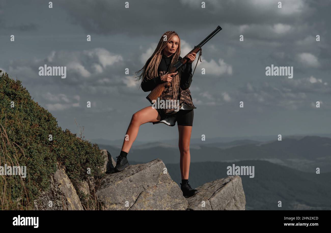 Hunter girl. Hunting in America. Young hunter woman holding gun and ...