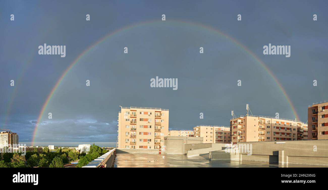 Rainbow over buildings Stock Photo - Alamy