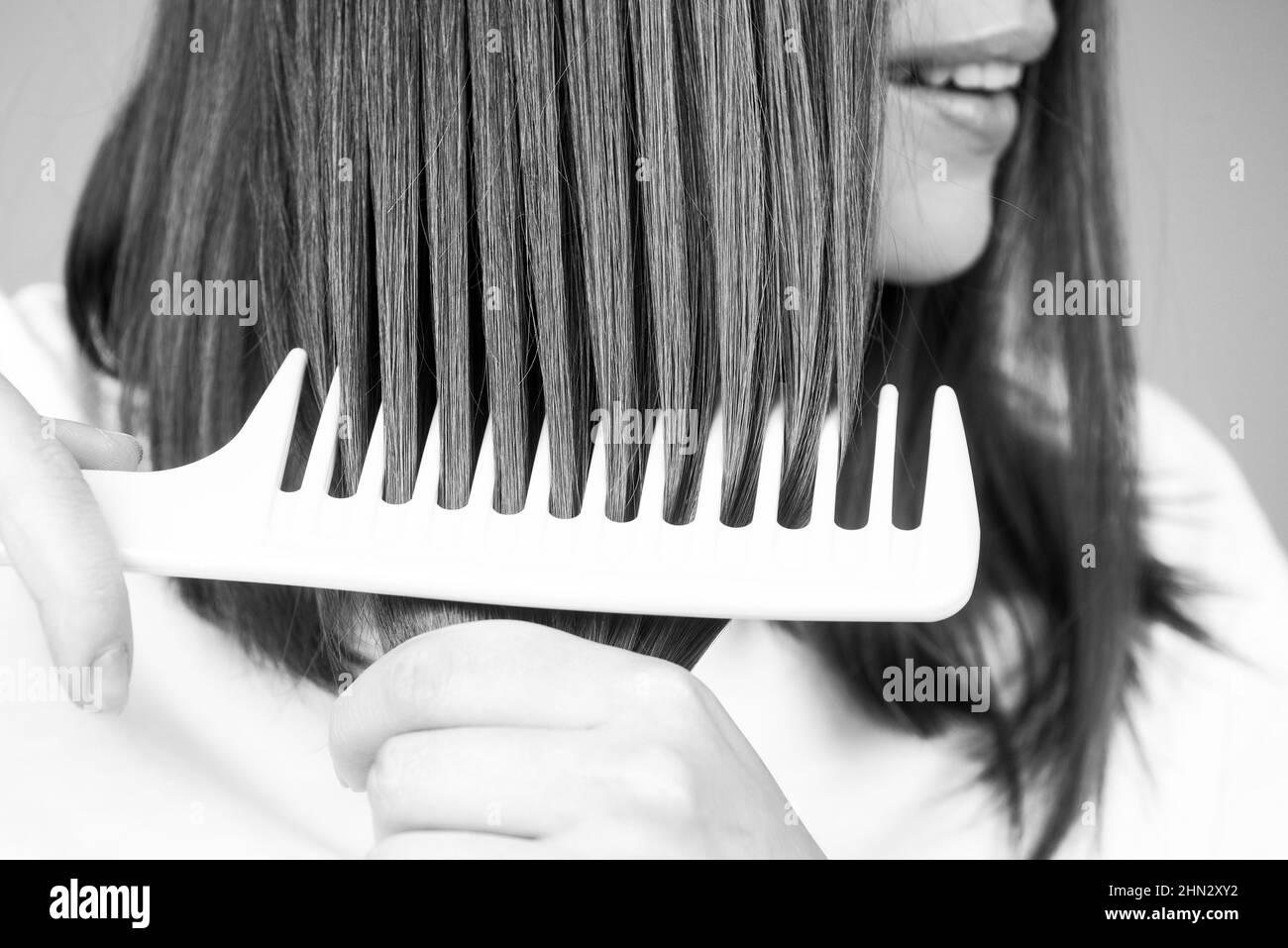 Close up combing healthy and shiny hair, isolated on studio Stock Photo ...