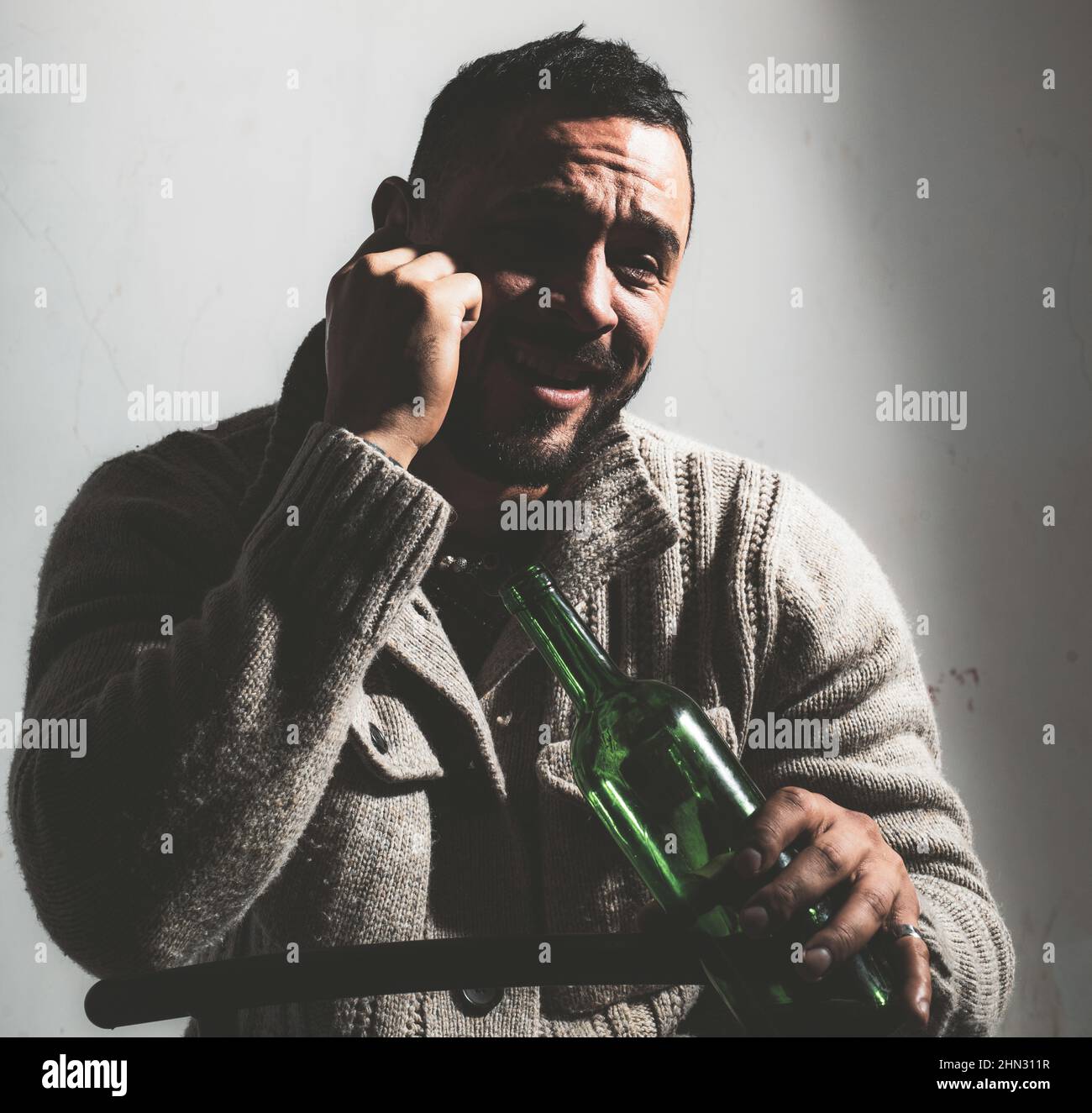 Drunk man drinking wine. Depressed guy with bottle alcohol, sad and unhappy Stock Photo - Alamy