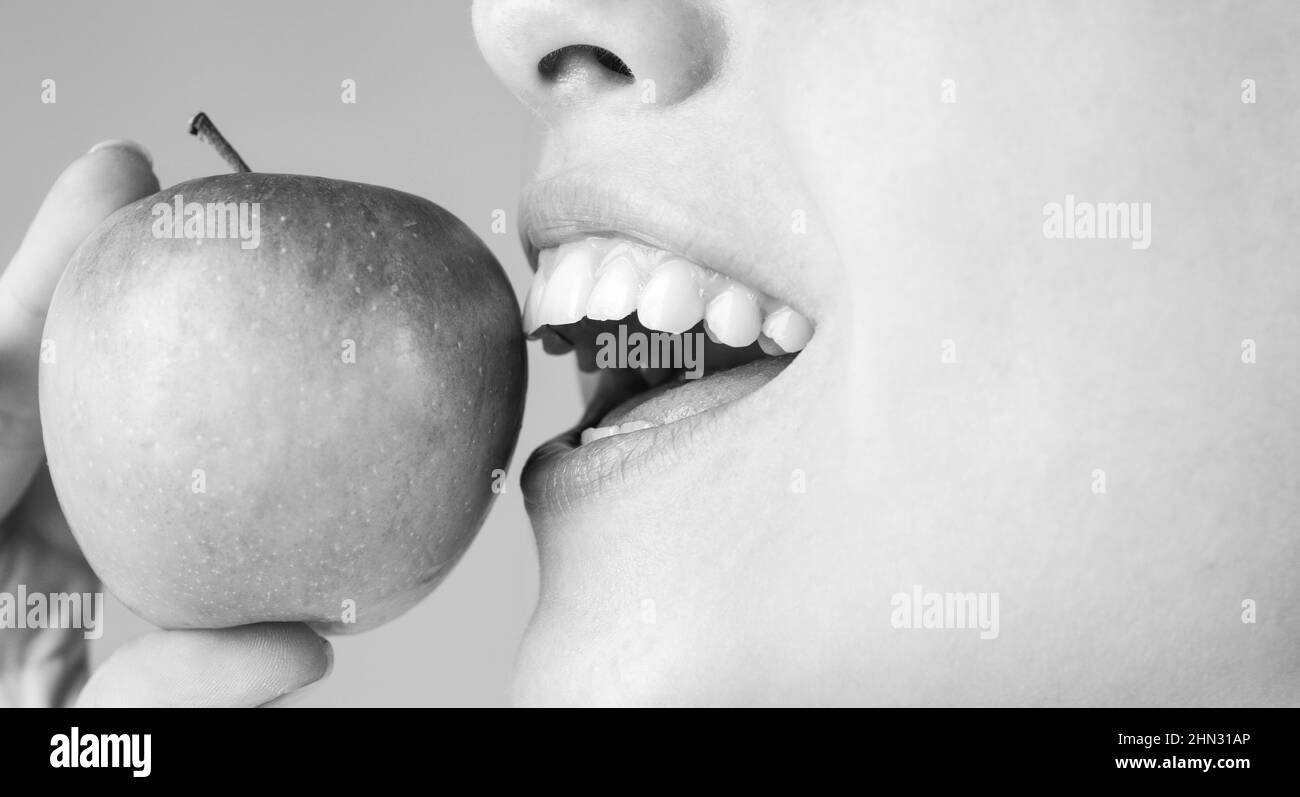 Beautiful young woman eating a apple. Healthy white teeth close up with ...