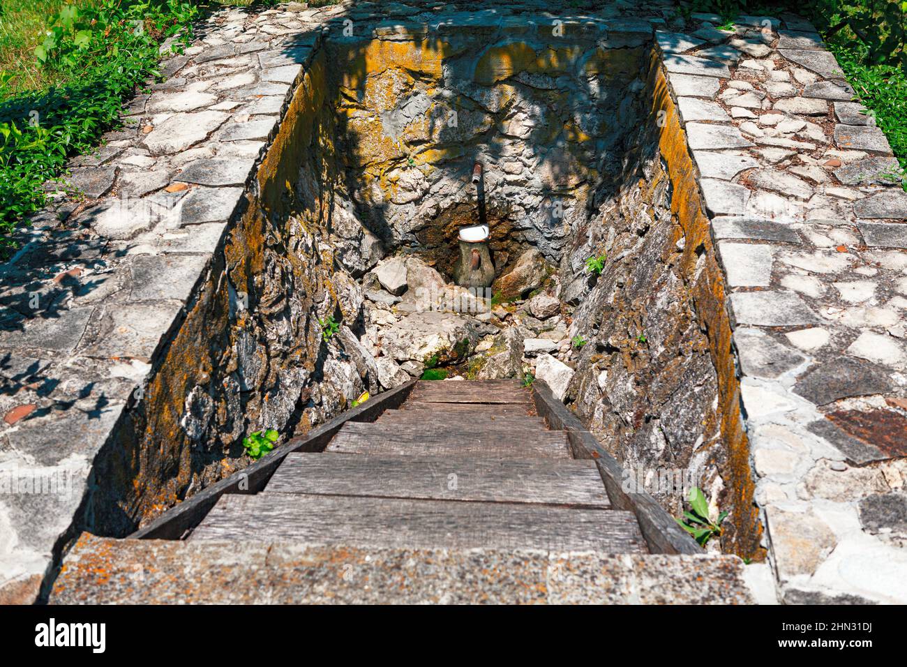 Spring with pouring water . Place for drinking water in village Stock ...