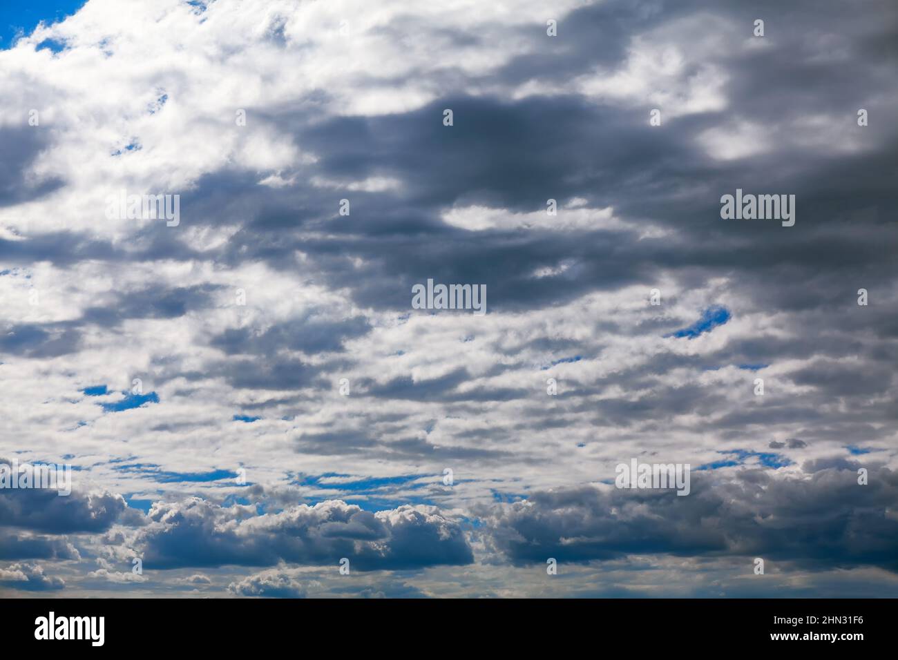 Heap of clouds with sun rays in gray skyscape Stock Photo - Alamy