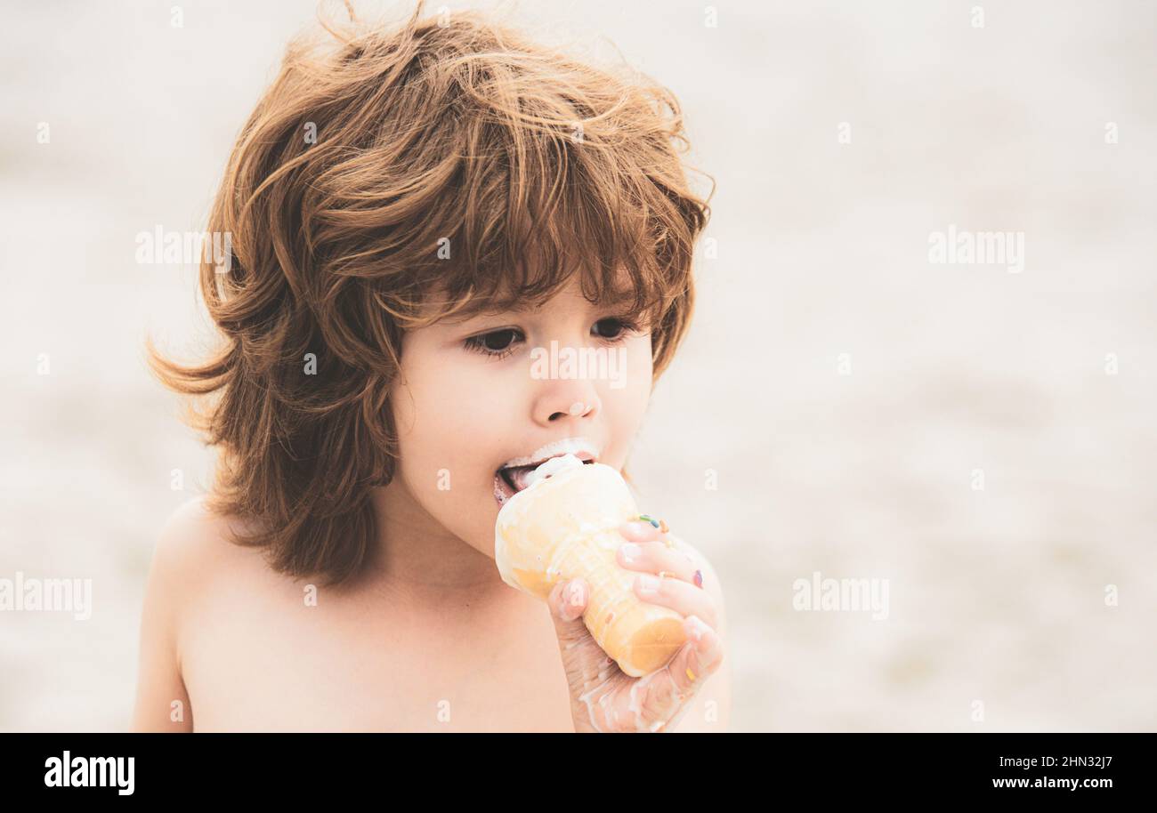 Child eating icecream. Kid with dirty face eating ice cream Stock Photo ...