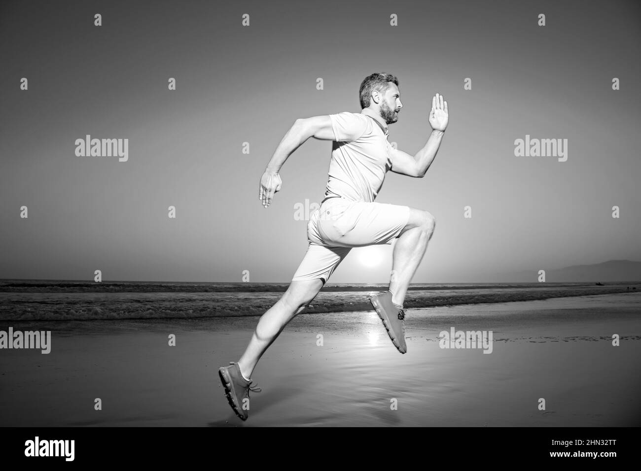 Athletic young man running in the nature. Fit man fitness model working ...