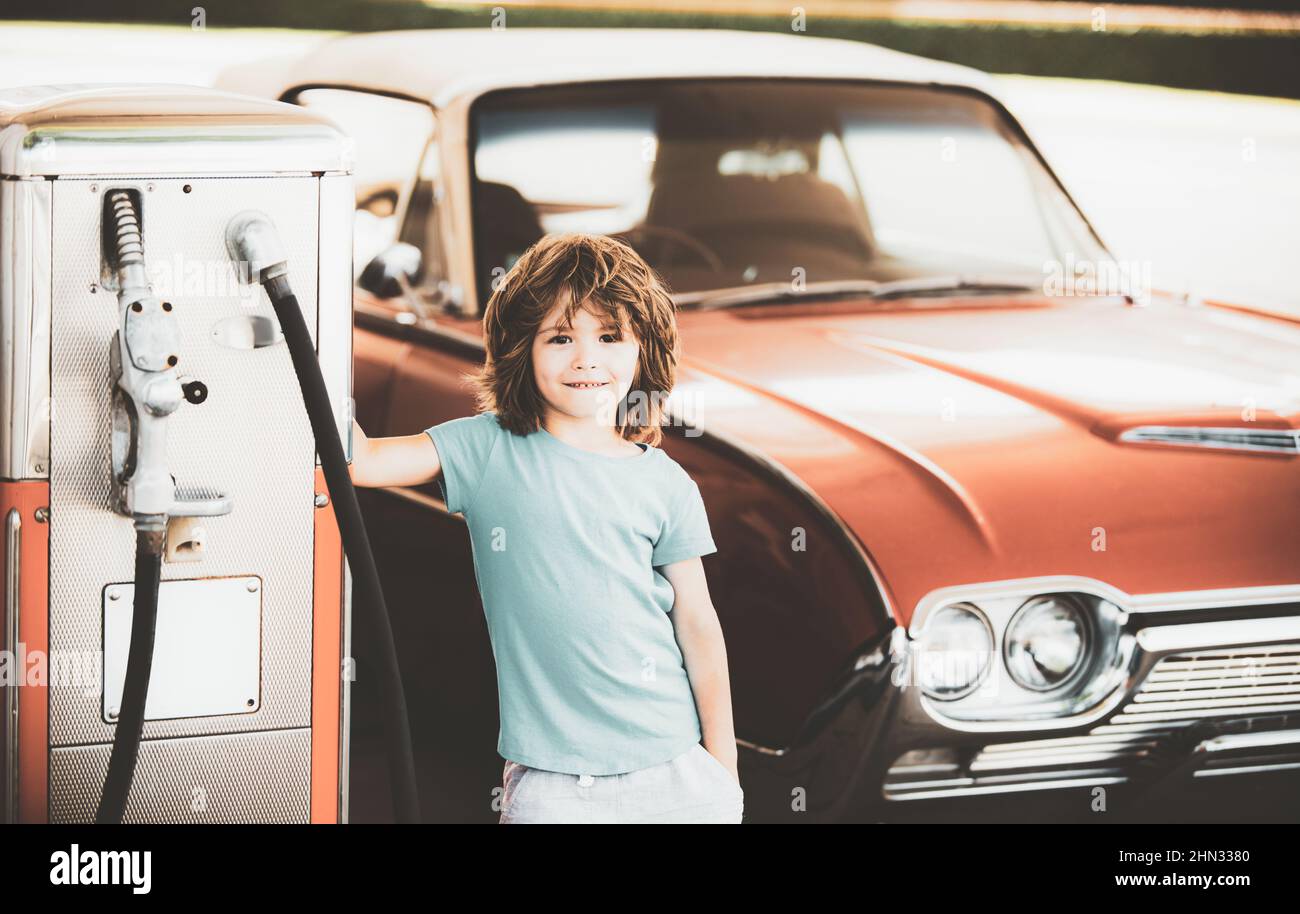 Retro gas station. Smiling Kid boy at the gas station. Waiting for fuel ...