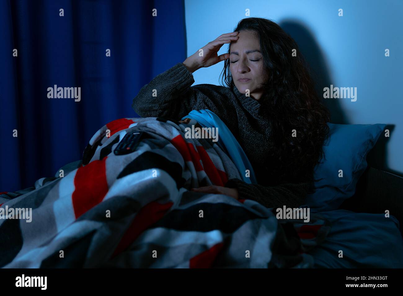 Insomnia, Depressed woman sitting up in bed at night, she can't sleep ...