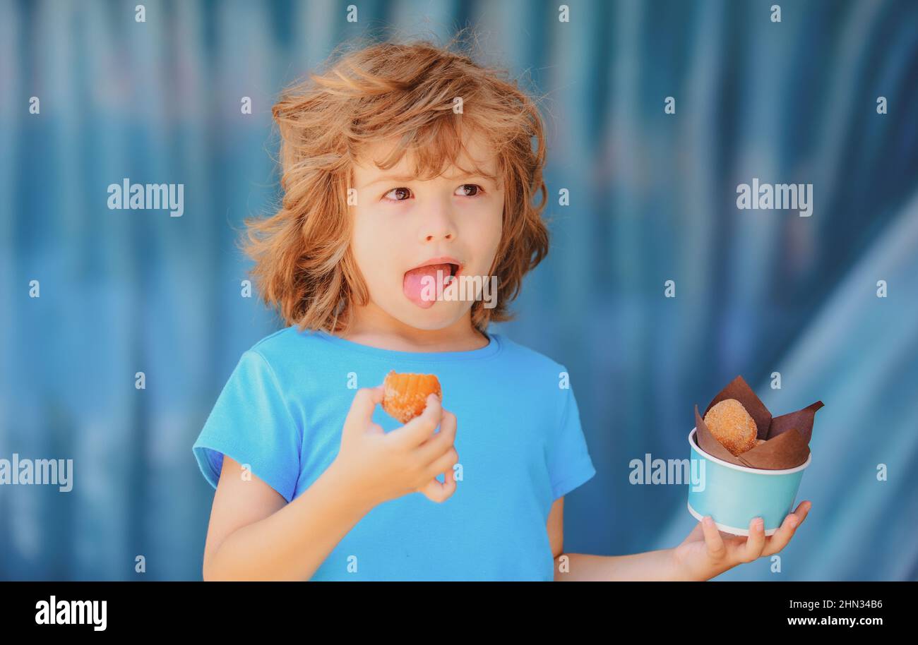 Kids lunch fastfood. Little boy child eating cookies outdoors in sunny ...
