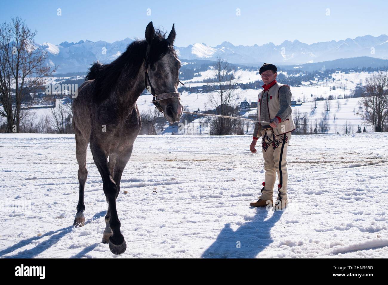 Highlander dressed in traditional clothes seen with a horse. Every year ...