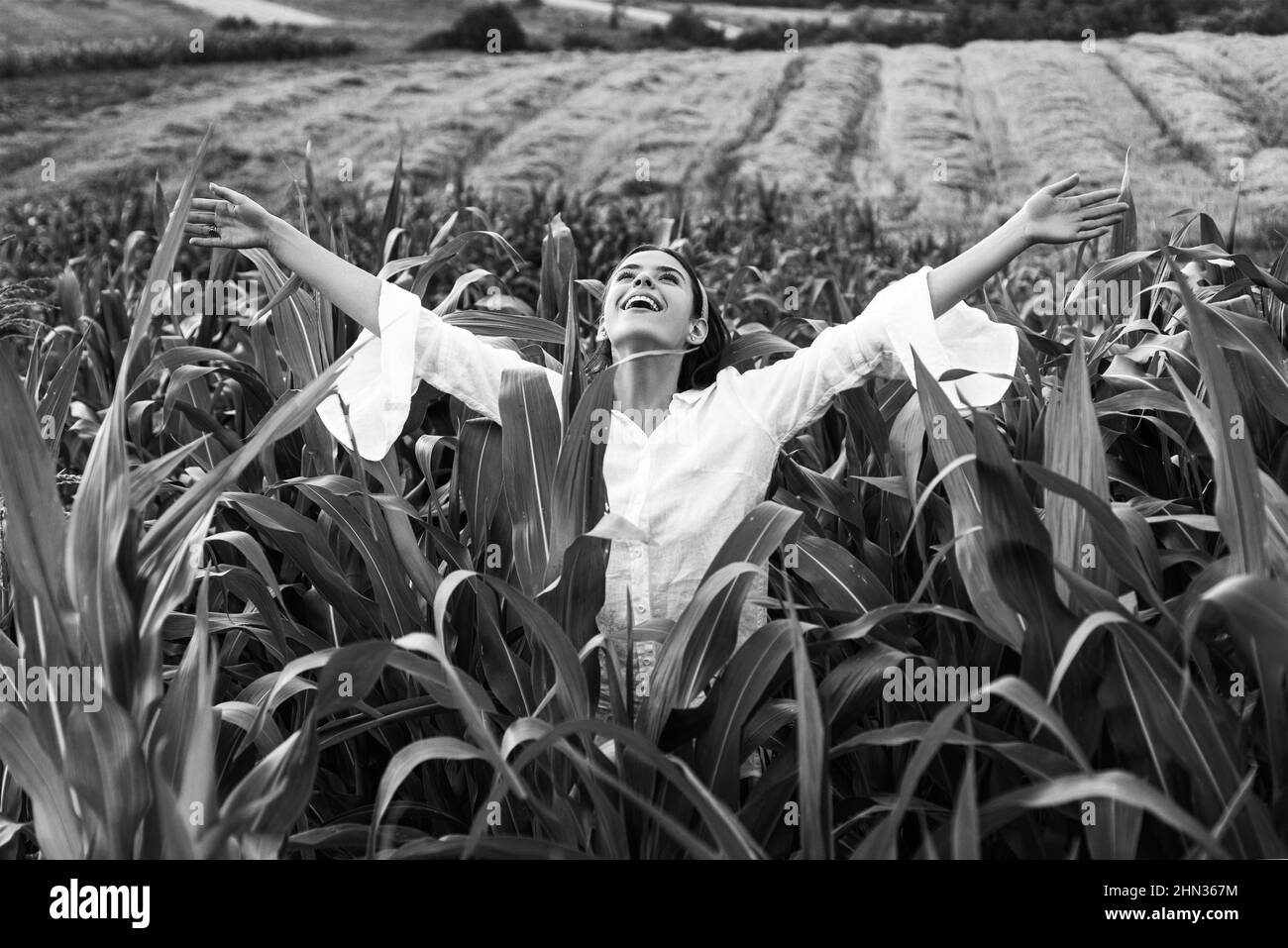 Cheerful woman posing in the corn crop, agriculture and cultivation ...