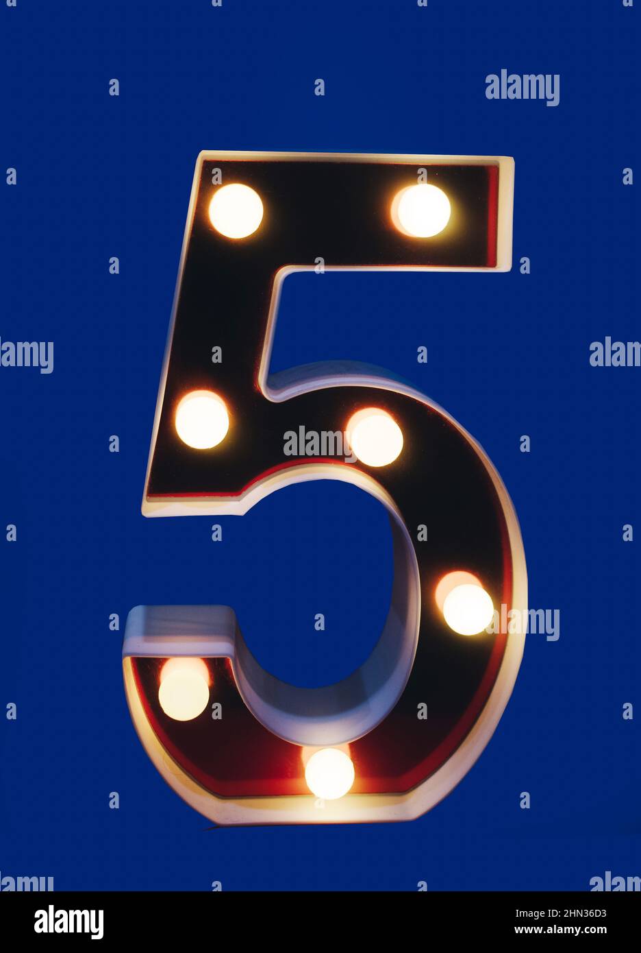 Illuminated shining number five 5 at isolated background, birthday ...