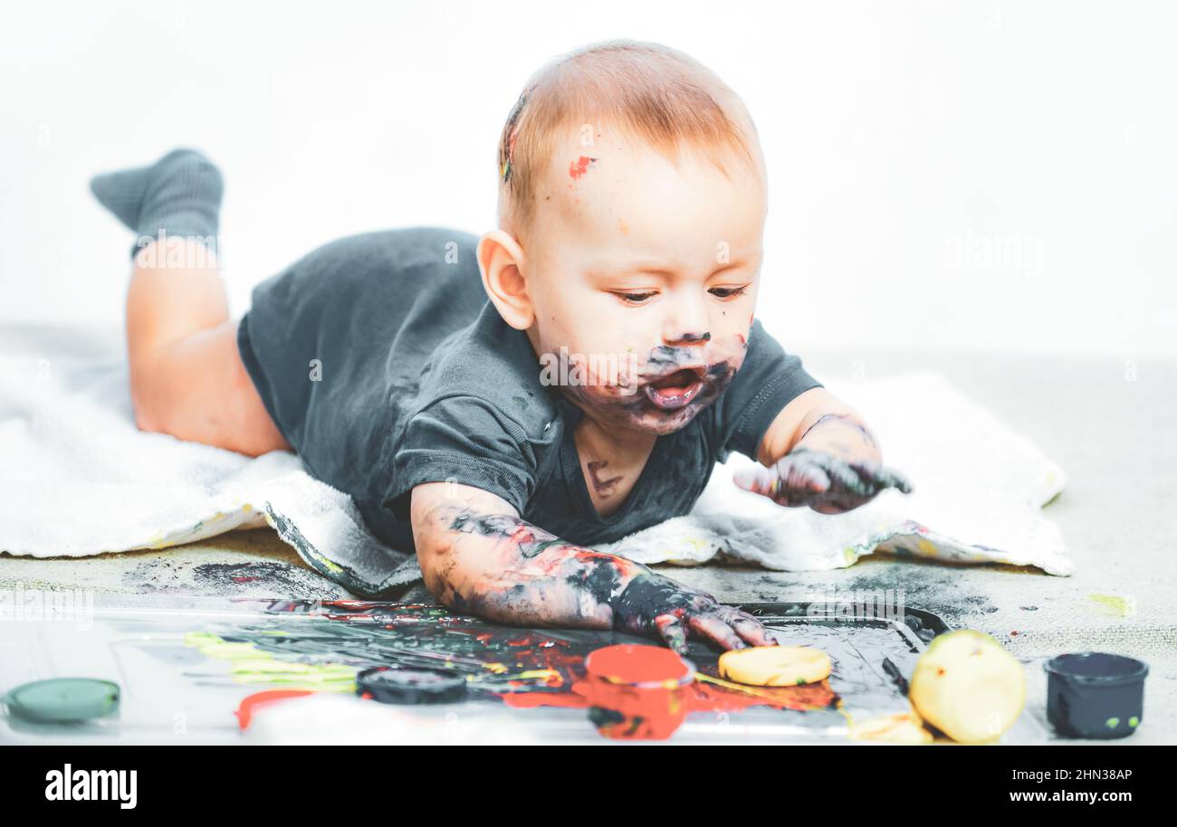 Colorful painted hands in a baby. Beautiful happy baby. Cute little ...