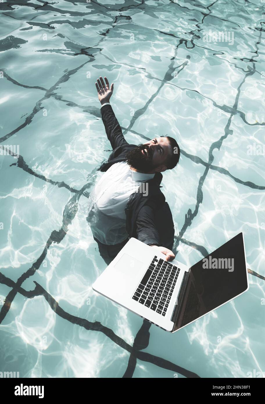 Funny and crazy man Freelancer in suit using a computer in swimming ...