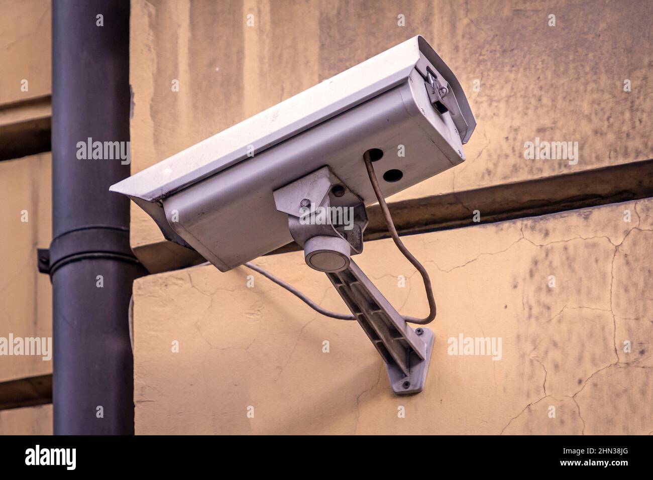 CCTV camera surveillance on the street attached to building facade ...