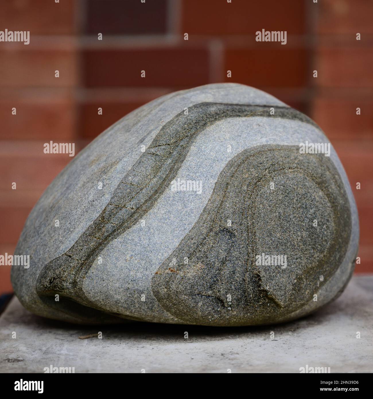 Closeup shot of a stone with abstract lines design on a blurred ...