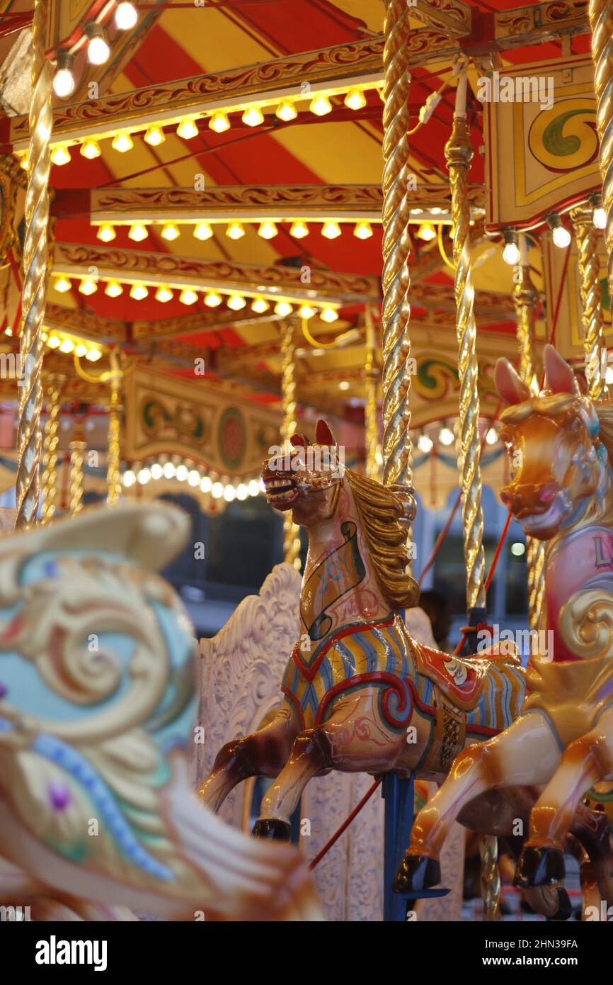 Vertical shot of a horse of the merry-go-round in an amusement park ...