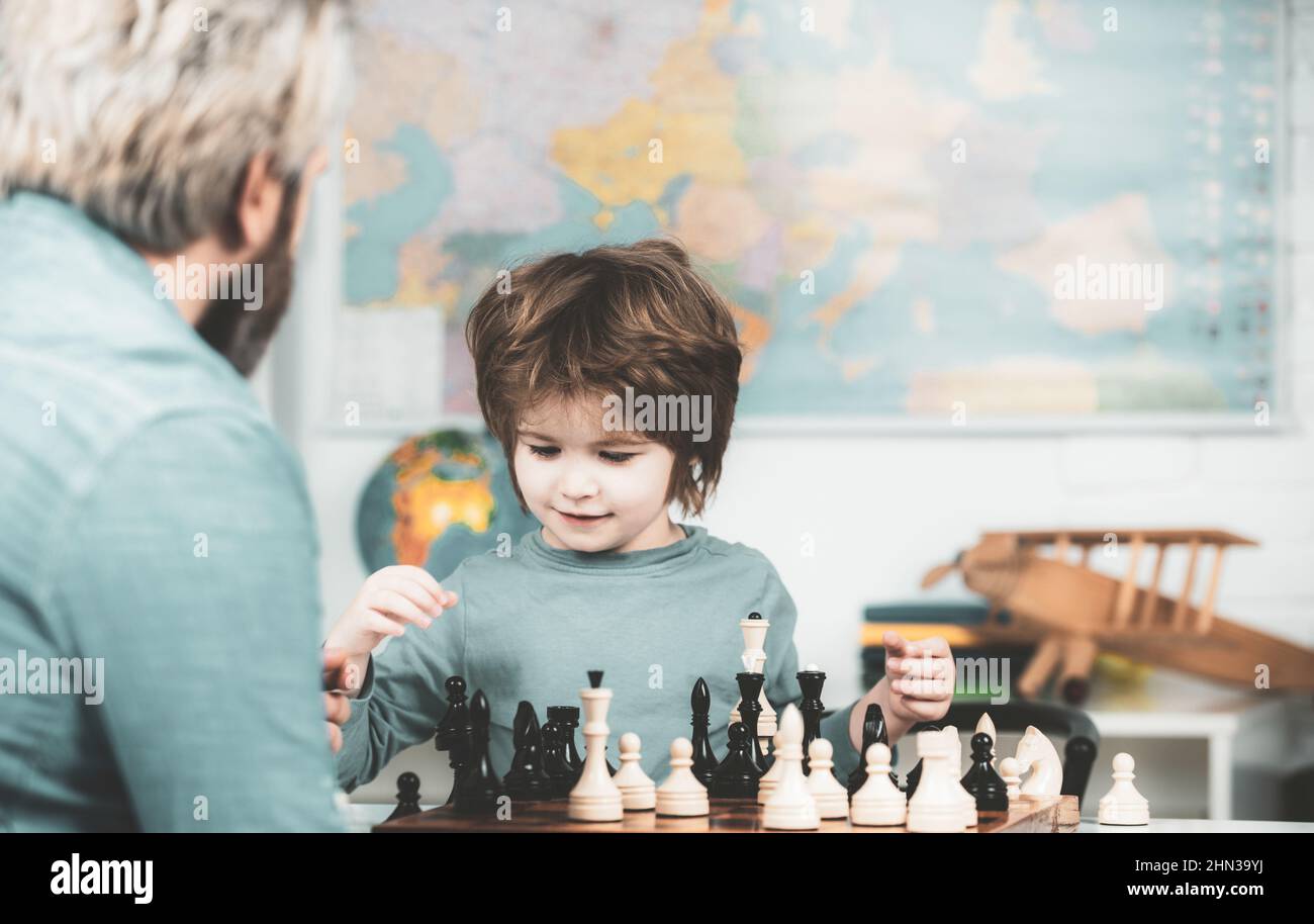 Concentrated boy developing chess strategy, playing board game. Child ...