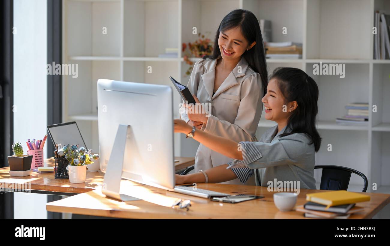 Cheerful businesswomen, business colleague are enjoying working ...