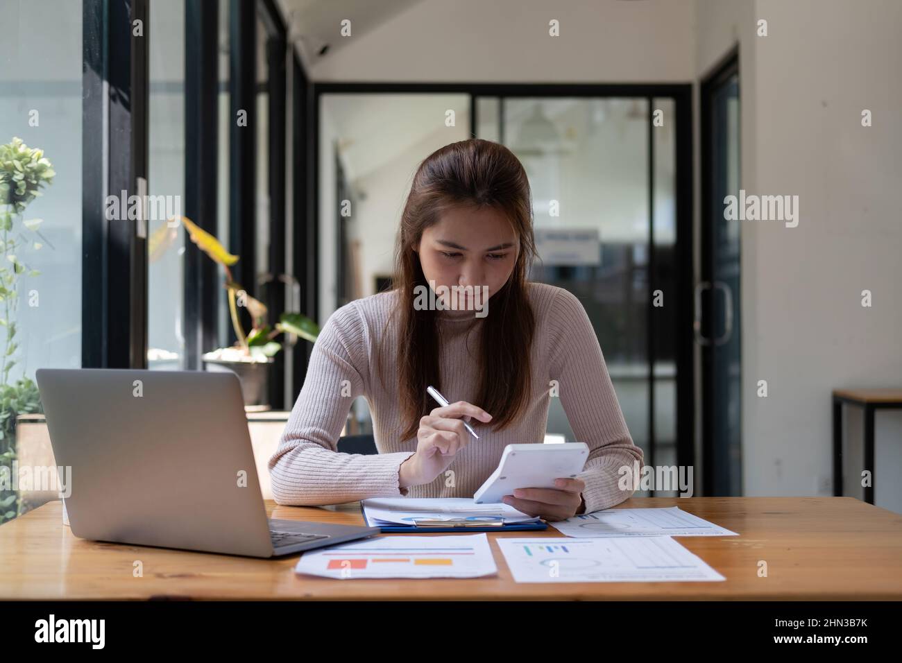 Close up of businesswoman or accountant working on calculator to ...